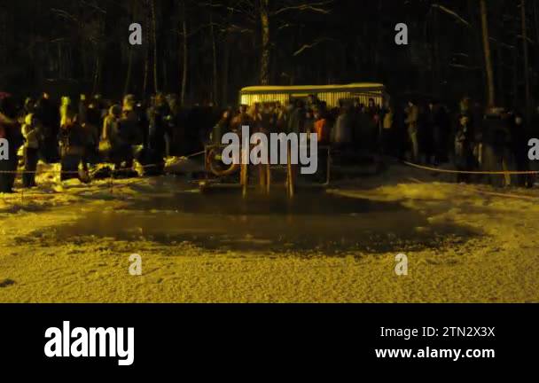 People dip into cold water during celebration of Epiphany Stock Video ...