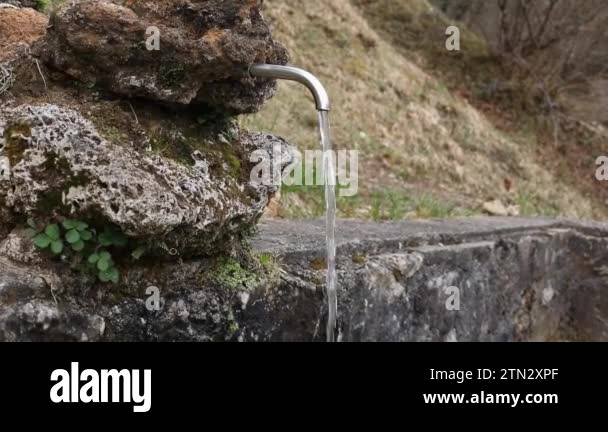 Source of water in the mountains. Natural source of clean fresh water ...