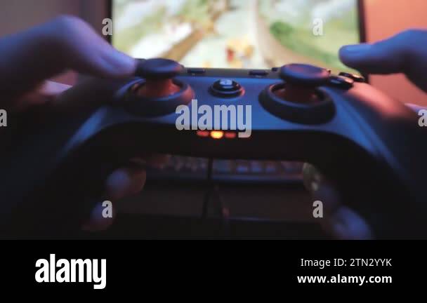 Teenage is playing a video game with a joystick.Joystick. Hands of a ...