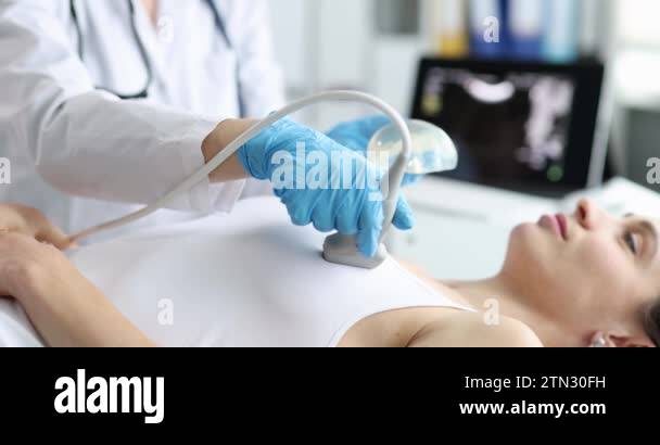 Doctor using ultrasound machine examining a woman chest and heart ...