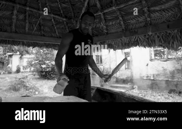 Indigenous Fijian man play on a Fijian Lali stick drum in Fiji Stock ...
