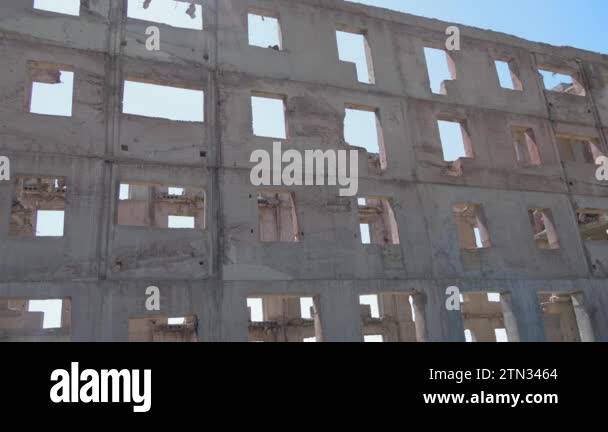 Large ruined building with pile of construction debris and concrete ...