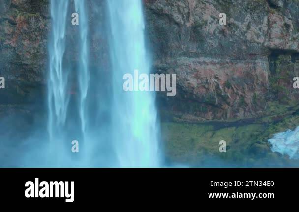 Nordic scenery of waterfall running down hill in iceland ...