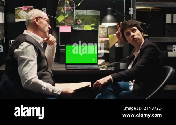 Police team using greenscreen display, working on criminal ...