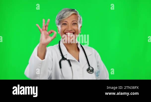 Smile, green screen and okay hand gesture, portrait of woman doctor on ...
