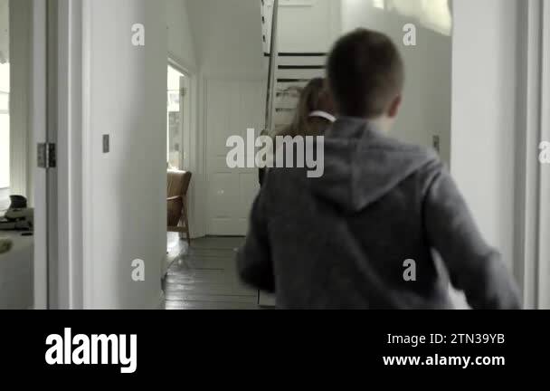 Teenagers brother and sister running on staircase Stock Video Footage ...