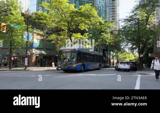 trolley bus in Vancouver city people running across the intersection ...