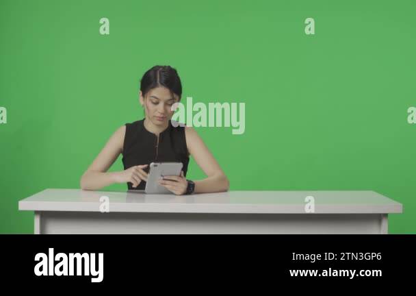 TV Live News Program. A TV presenter sits at a table in the studio ...