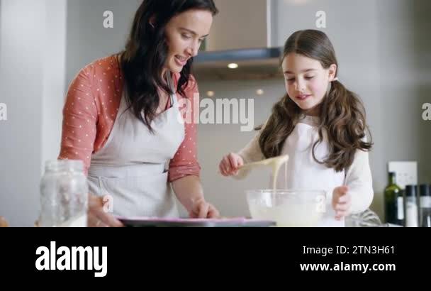 Baking, family and a mom with her daughter learning about cooking in a ...