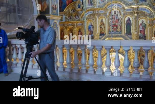 Camera Man With a Tripod is Shooting Thegreat Church of the Assumption ...