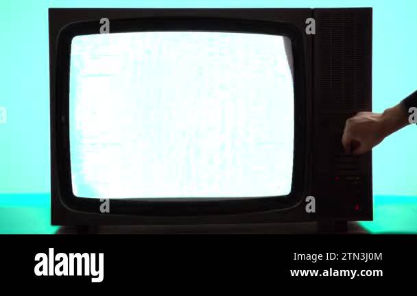 Person hand switching on and off TV channels on vintage television with ...