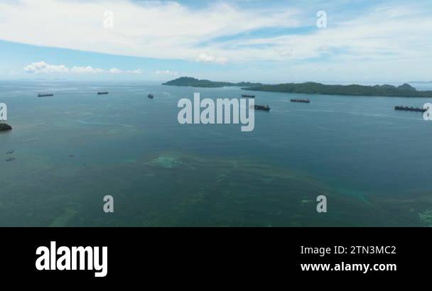 Coral reefs and turquoise water in the sea and merchant ship. Mindanao ...