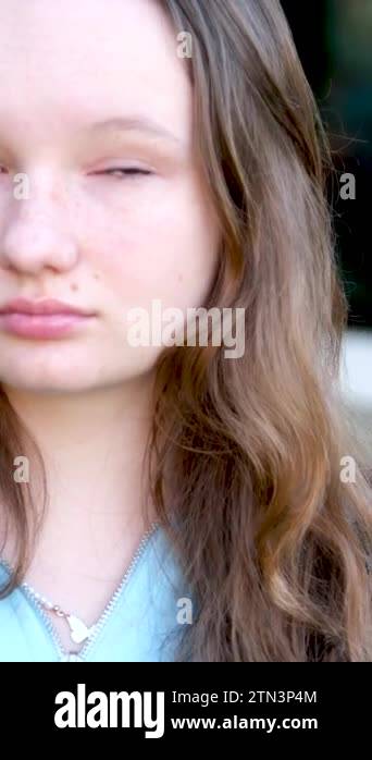 teenage girl looks at camera averts eyes first to left then to right ...