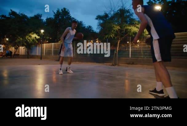 Two friends or rivals, teammates play practice basketball on outside ...