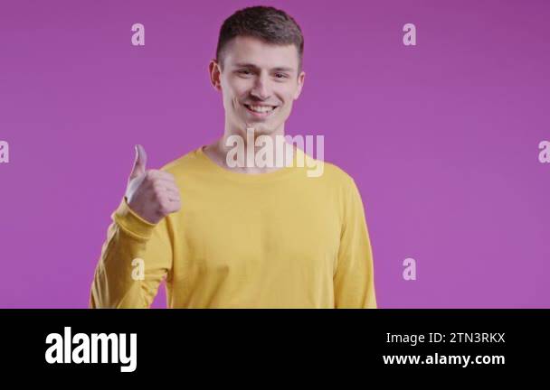 Positive man makes hand sign like, thumbs up gesture. Happy student guy ...