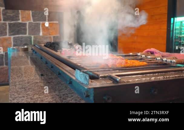 New concept of cooking meat on charcoal with smoke in cafe or ...