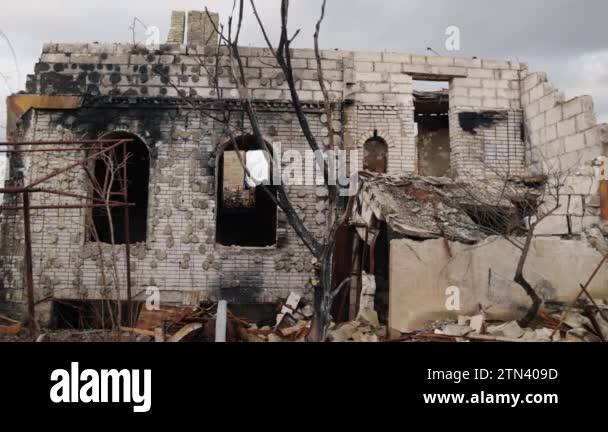 Gray debris, enemy missiles, ruined building. Collapsed building in midst of disaster and there ...