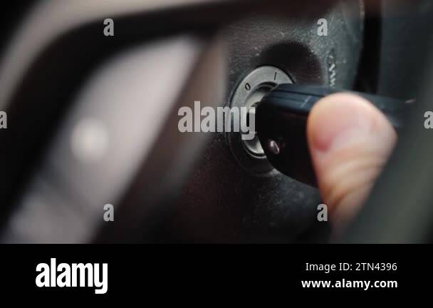 Man starts the car with key switch starting engine driver inserts the ...