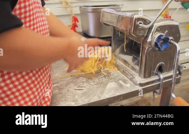 Making fresh pasta with a traditional style pasta machine. Cooking ...