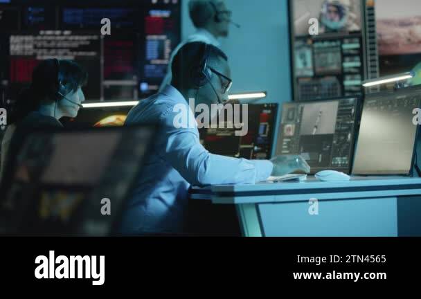 Male and female multiethnic flight control operators in headsets ...