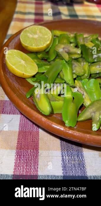 Seeds of Inga edulis, exotic fruit served in a clay dish accompanied by ...