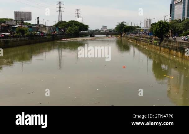 Polluted Ciliwung river with garbage in the slums of Jakarta, Indonesia ...