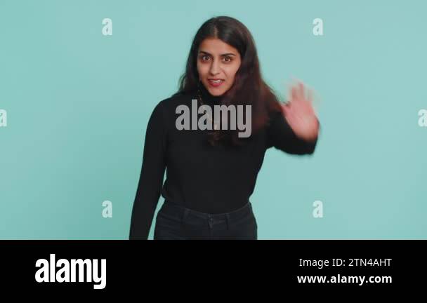 Hello. Come here, join us. Welcome. Indian woman stands aside and turns ...