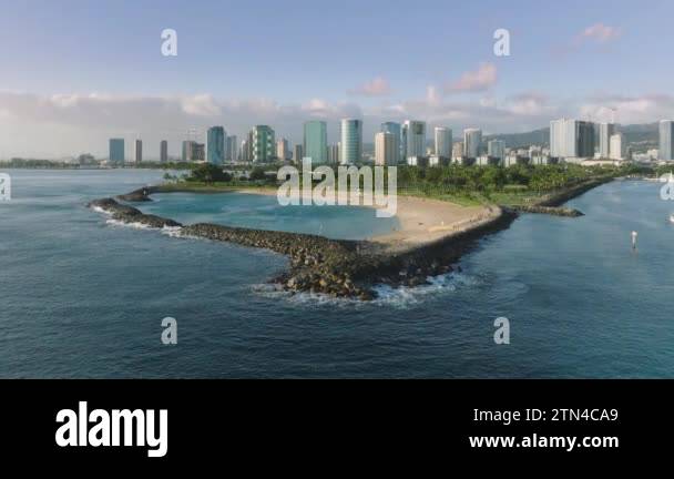 Scenic view above green Magic island beach park with Honolulu cityscape ...