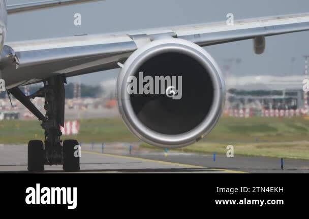 Hot air behind jet engine of plane at airport. Airplane is taxiing to ...