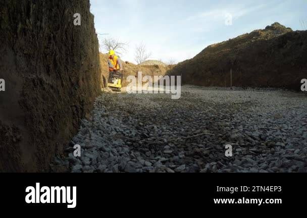 Man serving compacting machine. Stone compaction during the ...