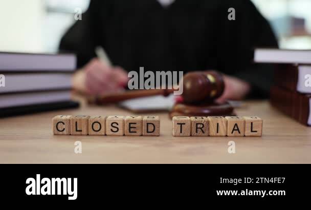Words Closed Trials made of wooden cubes against judge in black mantle ...