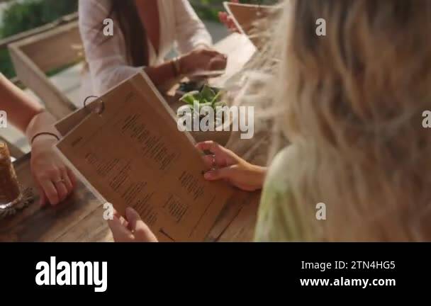 Female reading restaurant menu close-up. Woman hands holding menu in ...