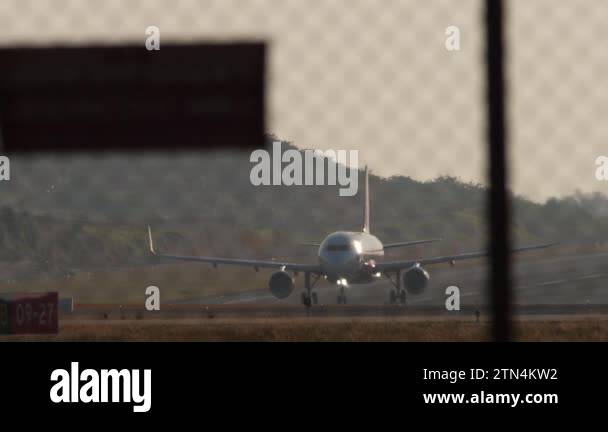 PHUKET, THAILAND - FEBRUARY 10, 2023: View through fence, Airbus A320 ...