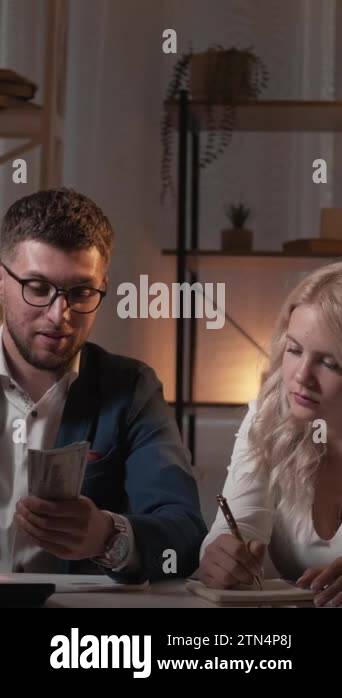 Vertical video. Business success. Teamwork couple. Financial budget ...