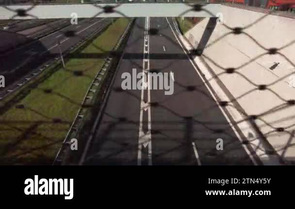 Sliding shot back view down from above the overpass, vehicles drive out ...