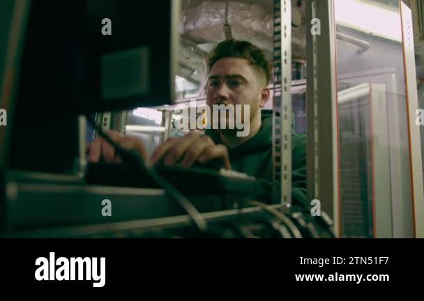 focused hacker data center hacking software system vulnerable cyber security server room ...