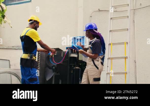 Diverse team of capable electricians brainstorming possible ways to ...