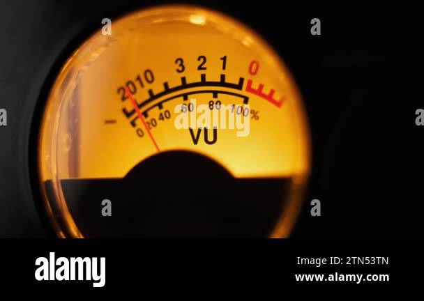 Analog dial indicator of audio signal level. Vintage arrow moves in ...