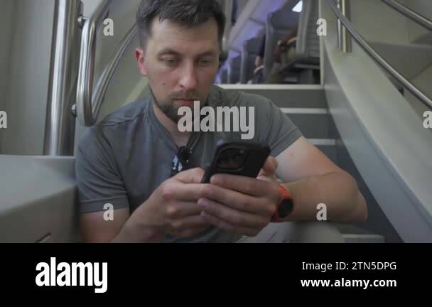 Young man travels on double decker train and sits on flyer using his ...