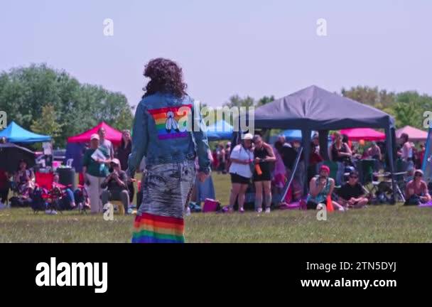 A person with Two spirit pride flag on the back. Pow wow Indigenous ...