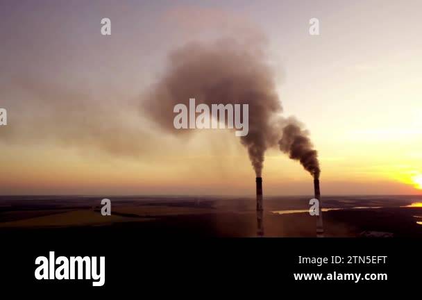 industrial factory chimneys produce toxic gases that pollute the air ...