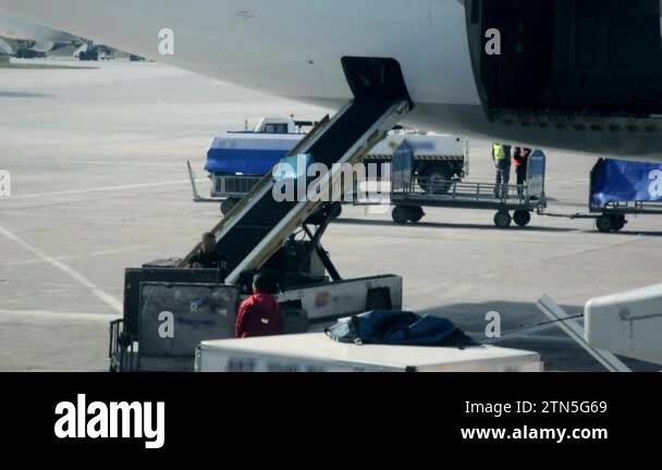 Luggage bags and aircraft cargo are transported and moved for visitors ...