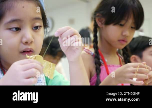 4K : Asian child learning to folding Japanese paper origami, art of ...