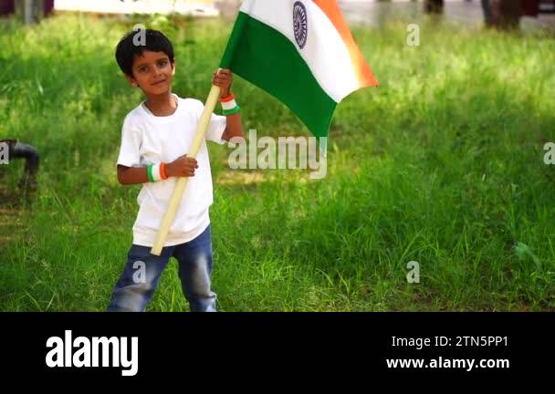 Cute little boy holding Indian flag in his hands and smiling ...
