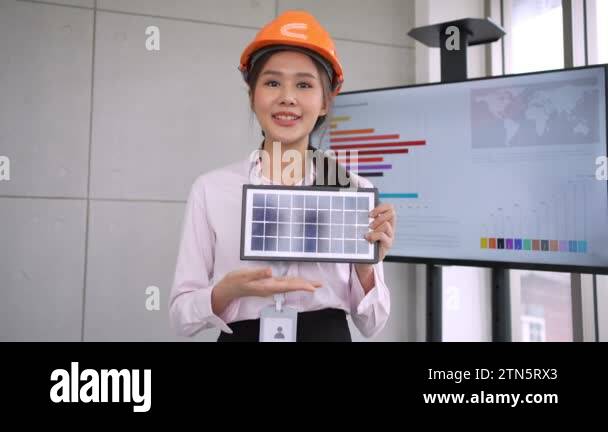Beautiful Asian young woman architect presenting sustainable Solar cell ...