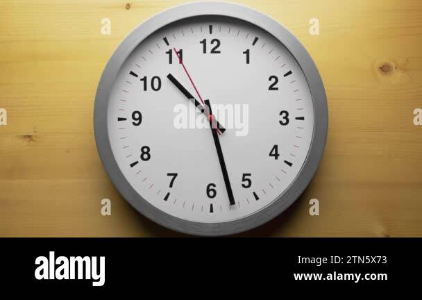 Close up a wall clock arrow showing hour and minute hand moving ...