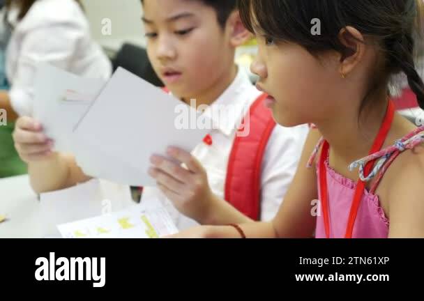 4K : Asian child learning to folding Japanese paper origami, art of ...