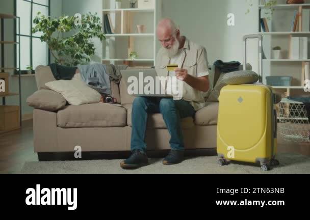 Happy Old Man Makes a Purchase in the Online Store With a Credit Card ...