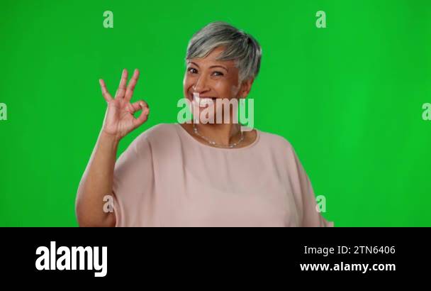 Smile, green screen and okay hand gesture, portrait of woman on studio ...