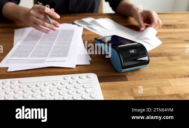 Woman accountant studying checks from payment terminal closeup 4k movie ...
